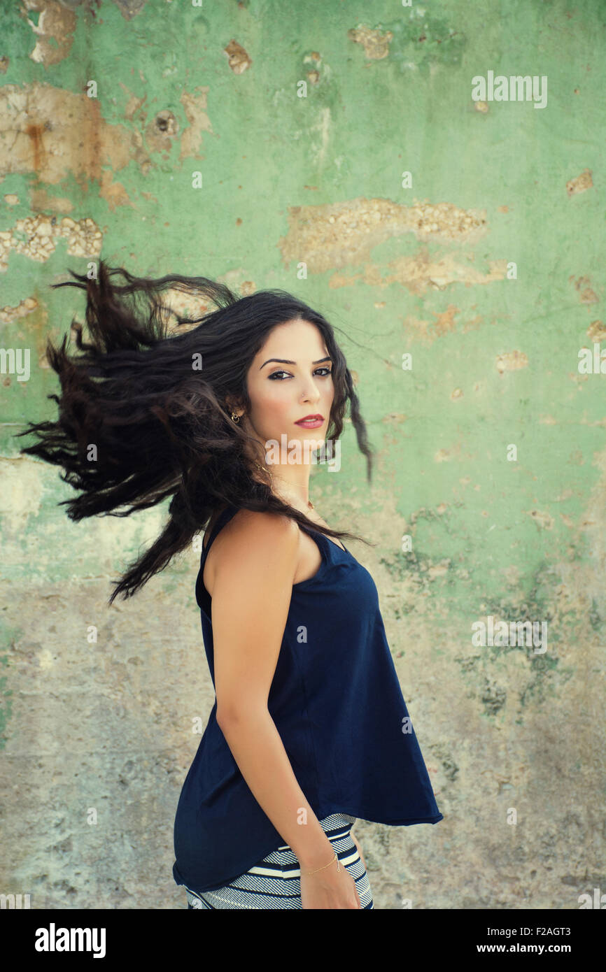 Beautiful young woman flicking hair Stock Photo - Alamy
