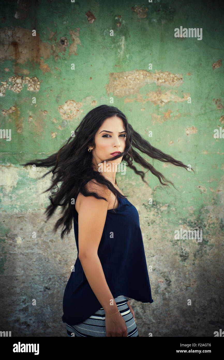 Beautiful young woman flicking hair Stock Photo - Alamy