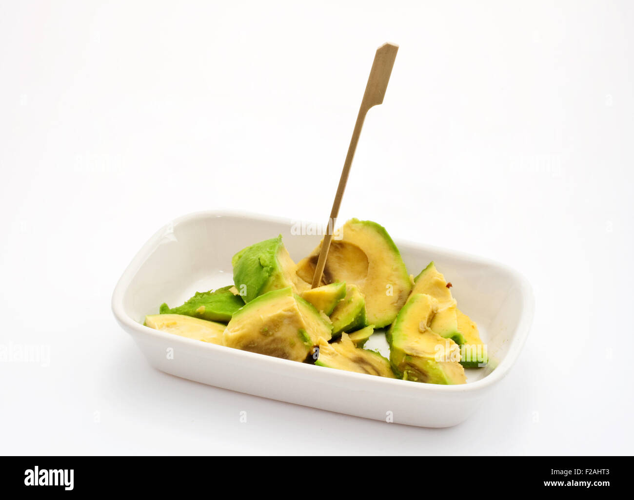 Avocado inside a saucer on white background Stock Photo - Alamy