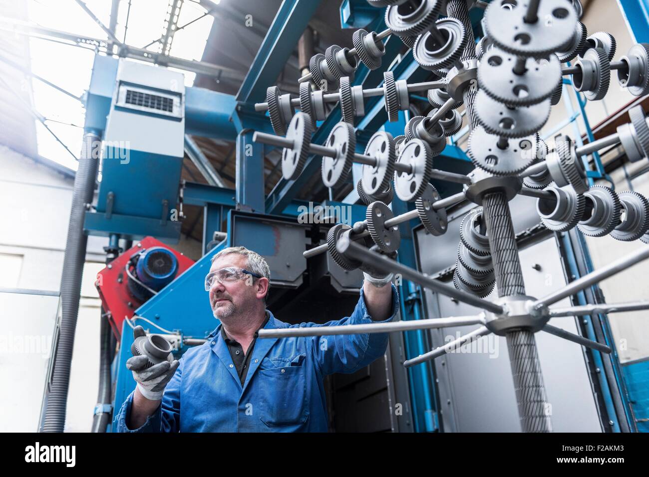 Engineer holding gear wheel in hi-res stock photography and images - Alamy