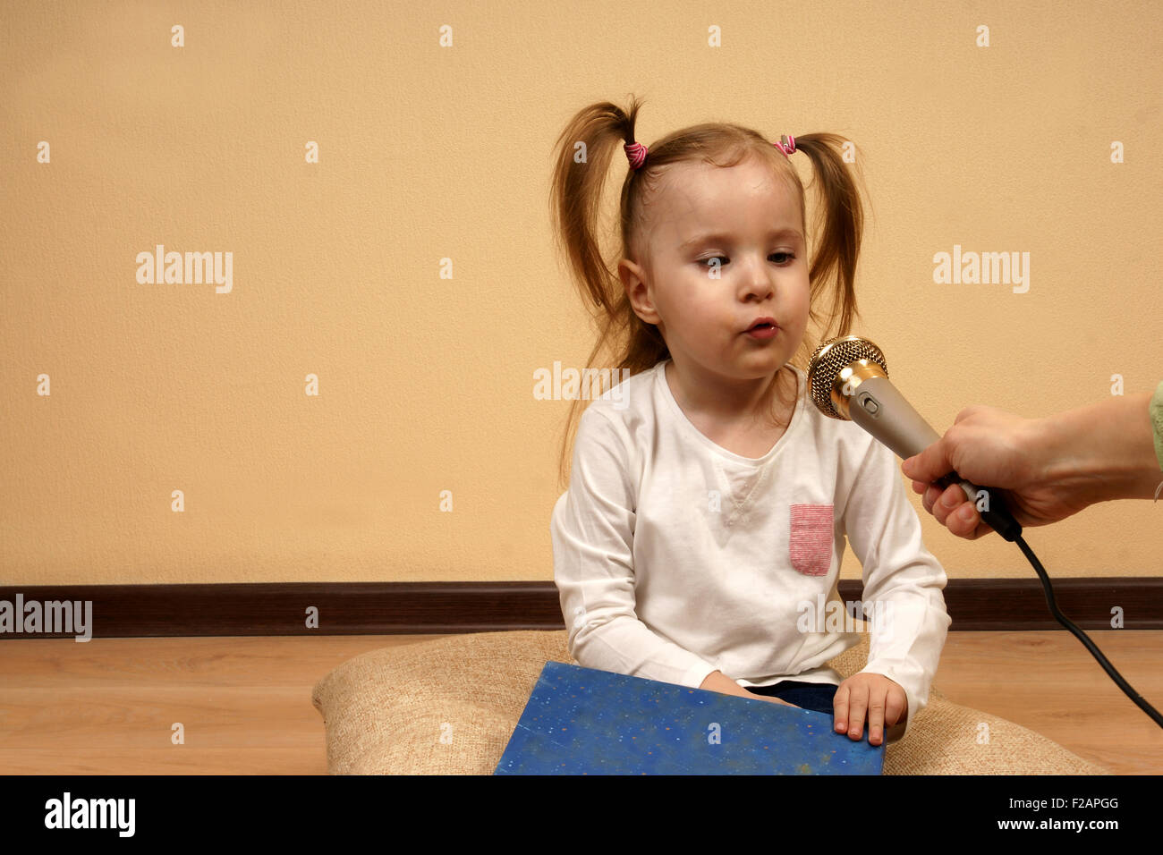 Cute girl giving interview Stock Photo - Alamy