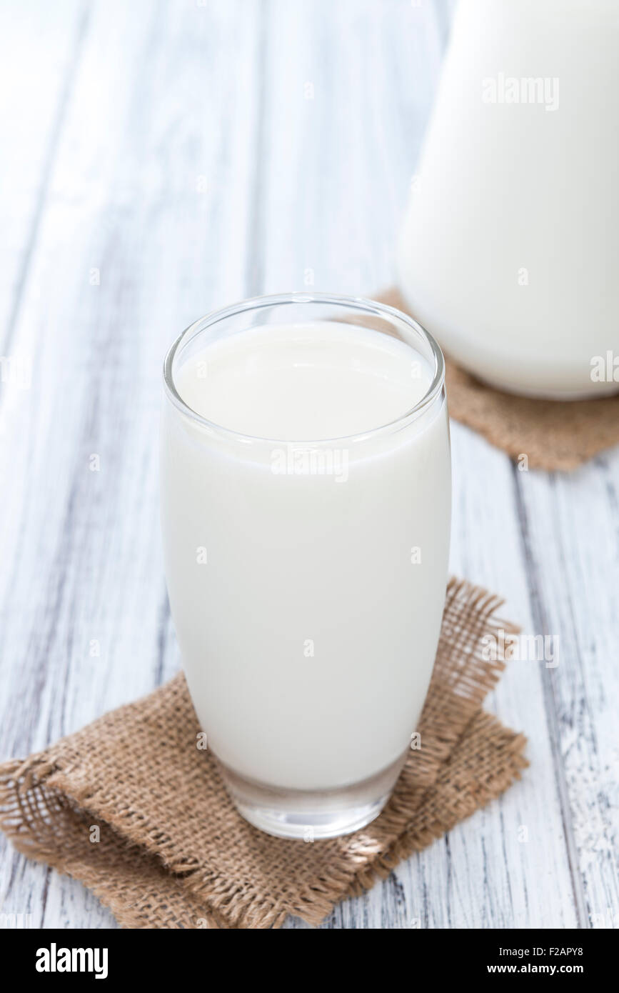 Portion of Milk on bright wooden background (close-up shot Stock Photo ...