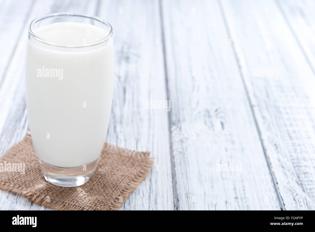 Glass of Milk (close-up shot) on wooden background Stock Photo - Alamy