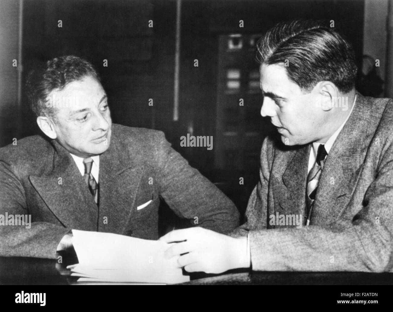 Roger Touley, confers with his attorney Robert Johnstone. May 23, 1949 ...