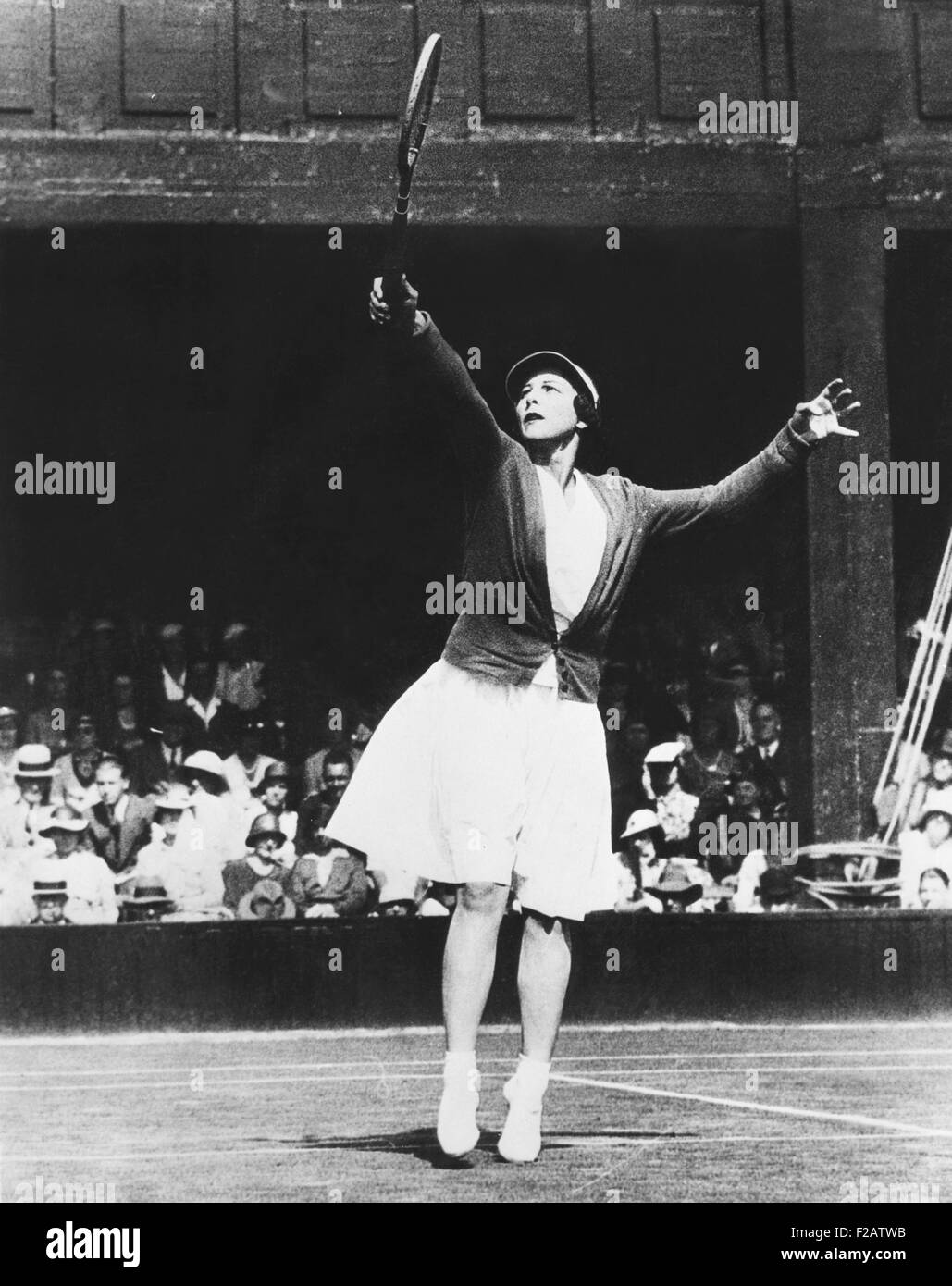 Helen Wills Moody returning a high one during her match with Mrs. J.P ...