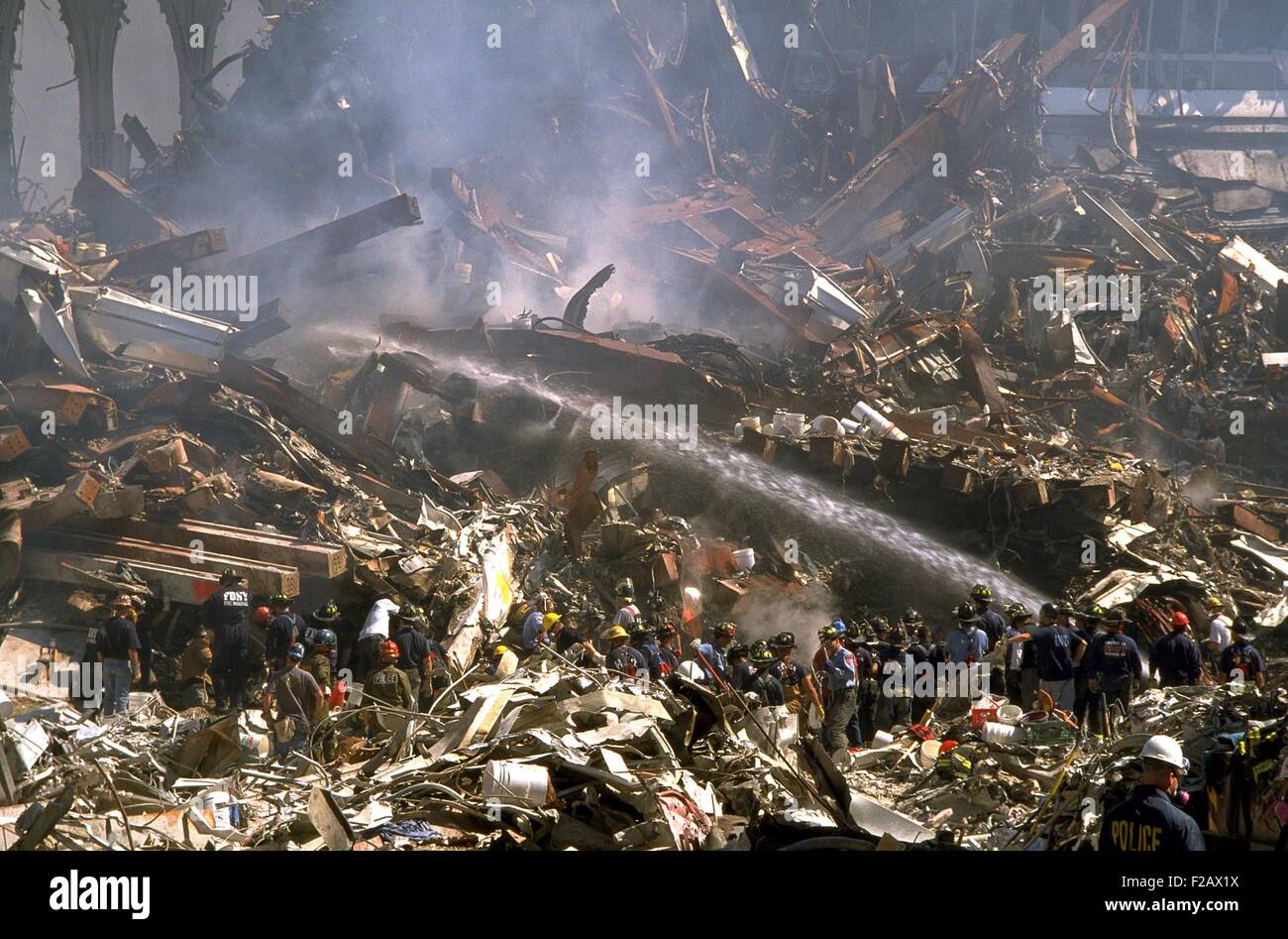 Firemen sprays still burning ruins of the World Trade Center on Sept 16 ...