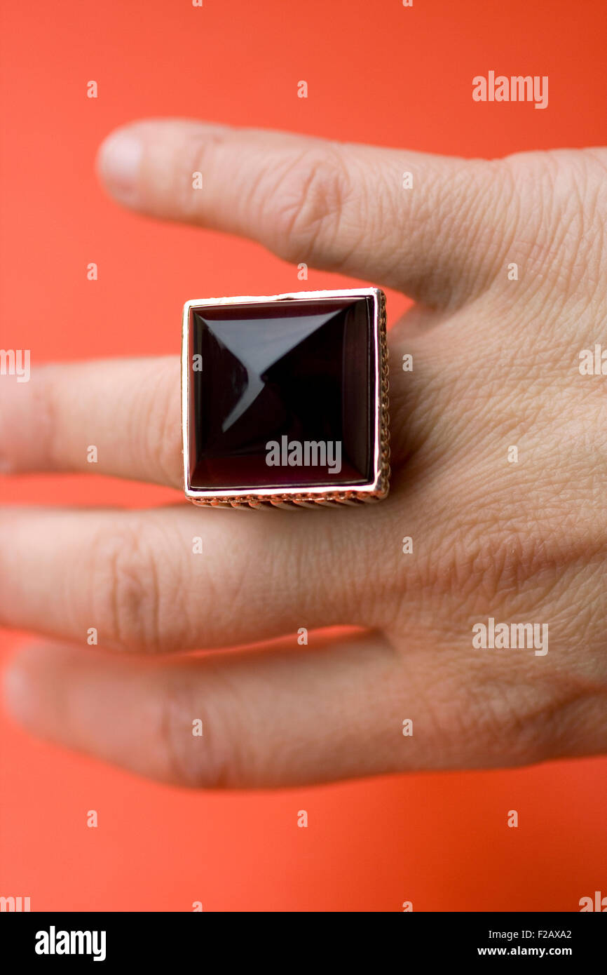 Ring with obsidian on red background Stock Photo - Alamy