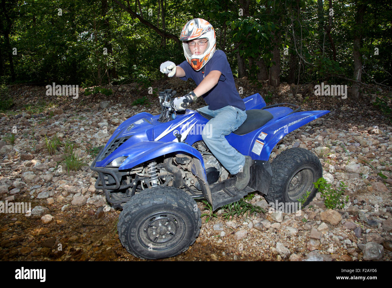 A boy riding on a blue ATV Stock Photo - Alamy