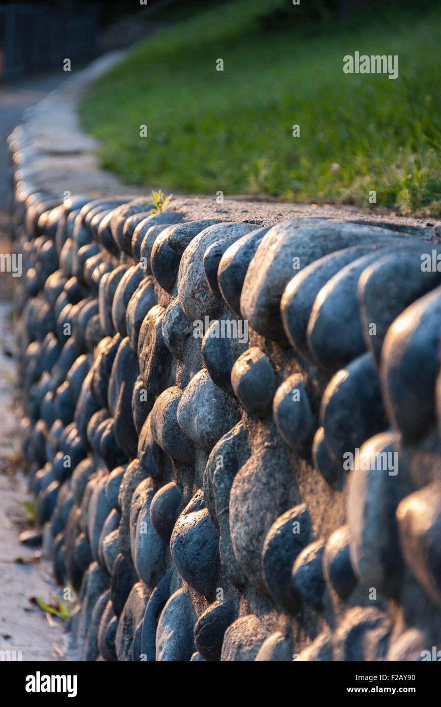 Cobblestone wall with sunlight Stock Photo - Alamy