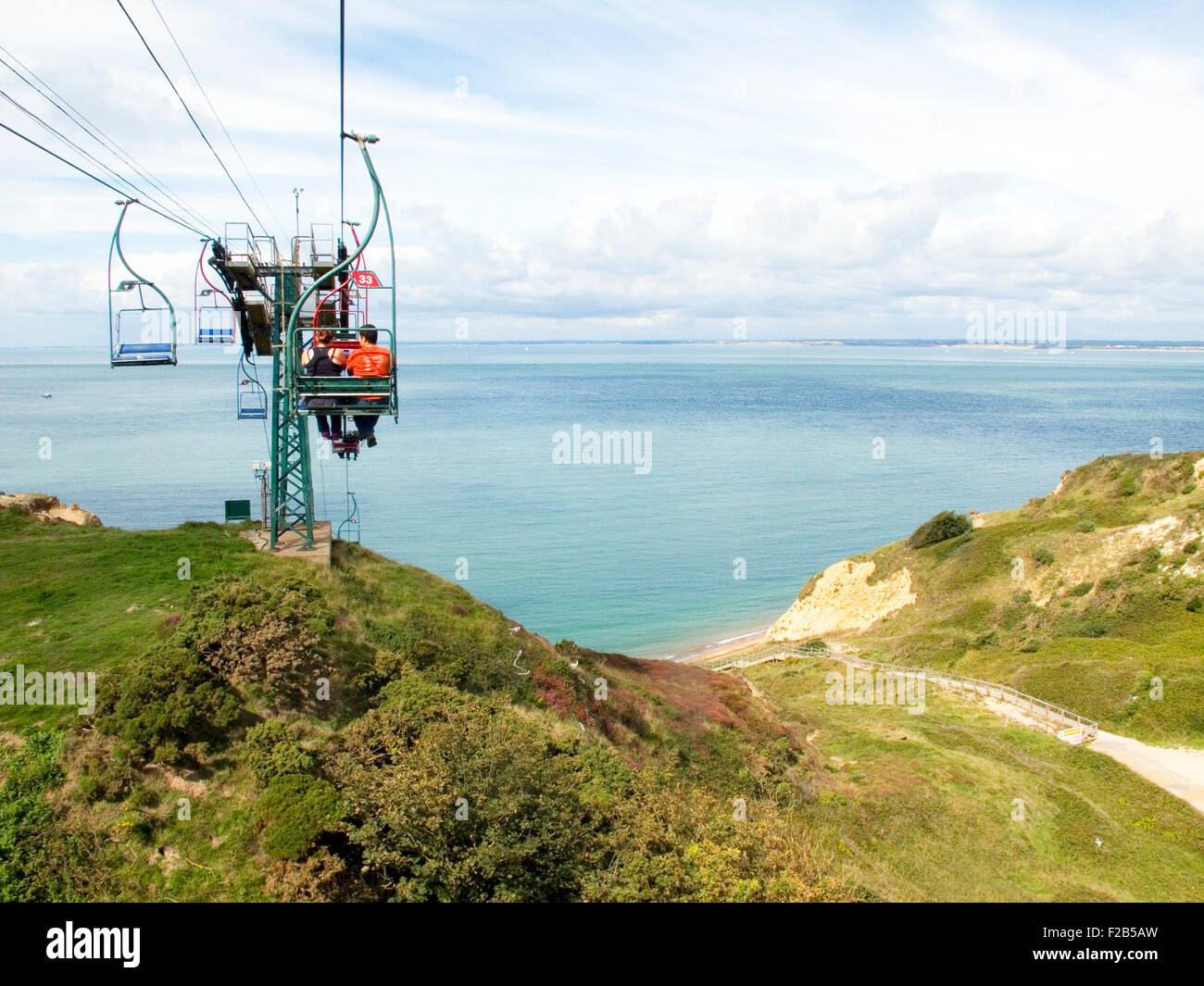 A chair lift takes people down to the sandy beach where they can see ...