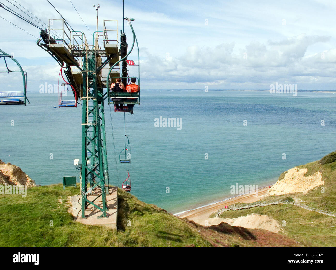 A chair lift takes people down to the sandy beach where they can see ...