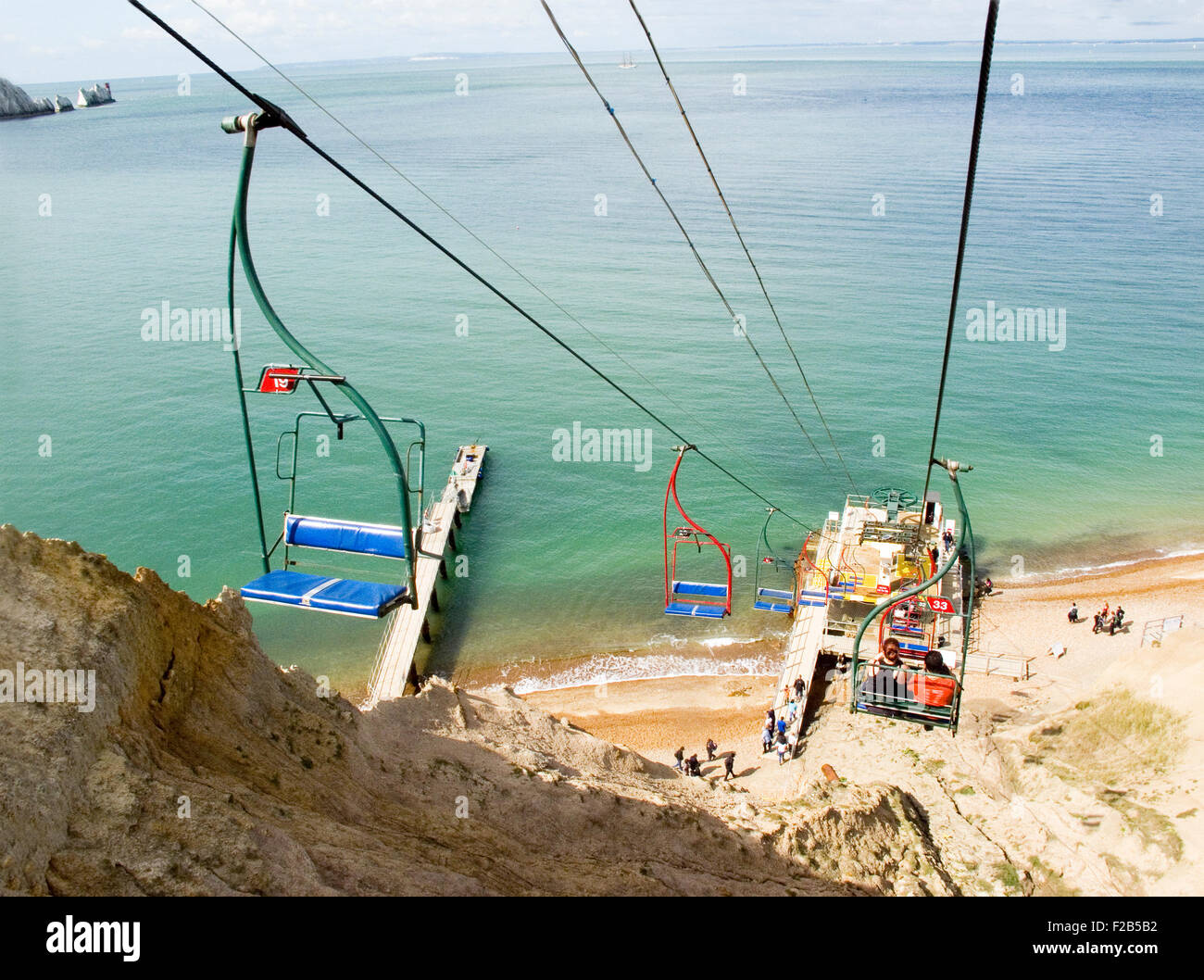 A chair lift takes people down to the sandy beach where they can see ...