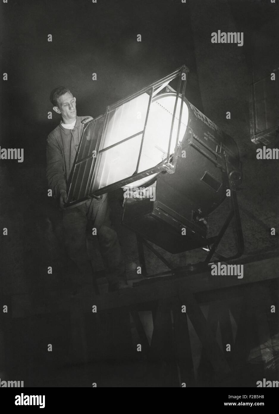 Film engineer using the Dunning Method. He places blue light filter on ...
