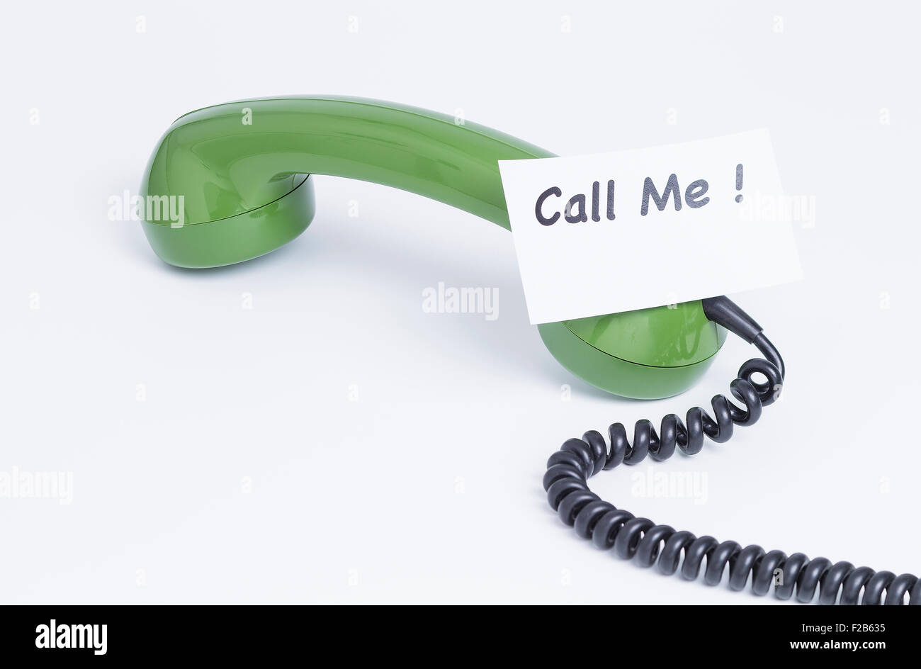 Image shows a telephone earphone with note "call me Stock Photo - Alamy