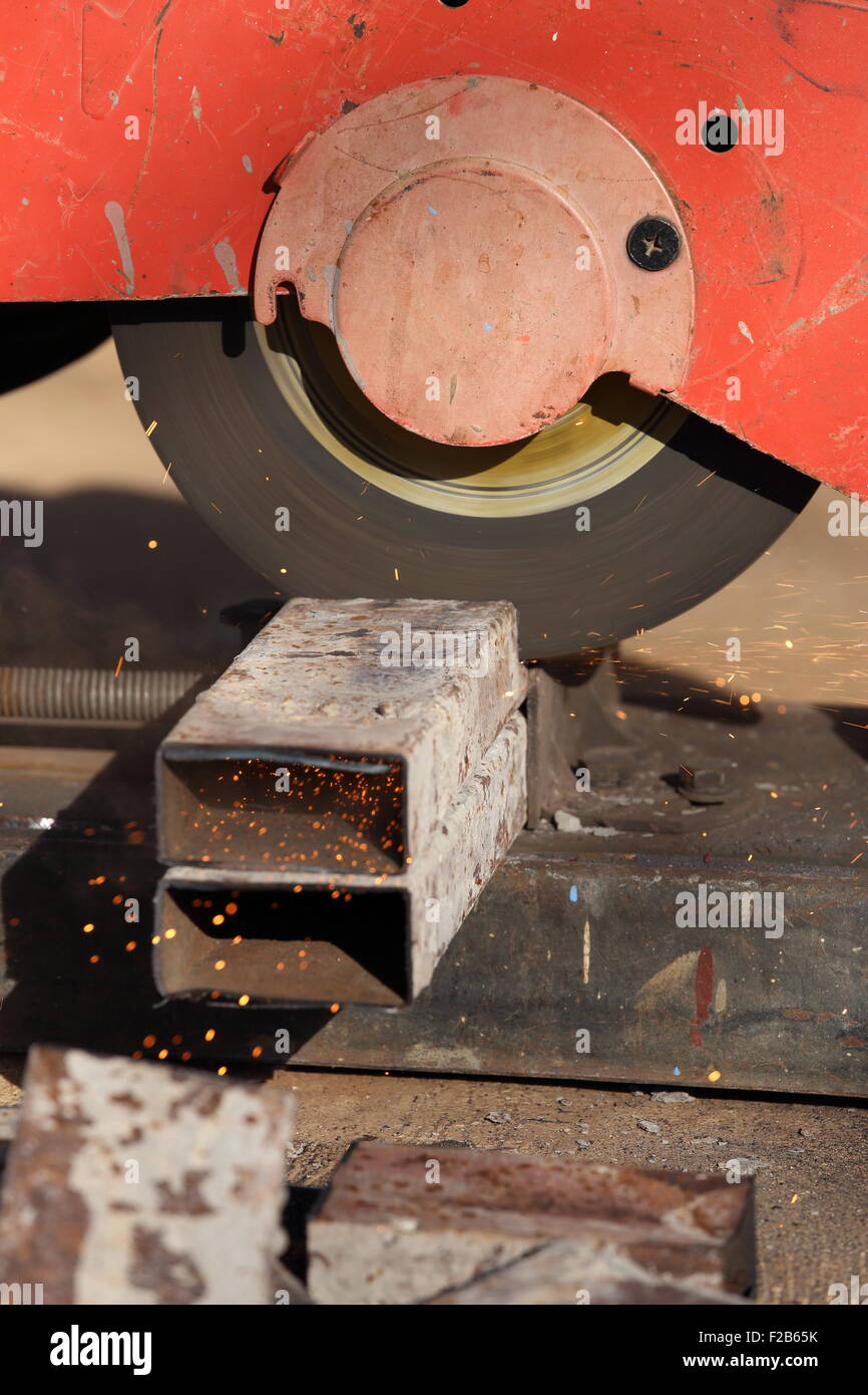 cutting a metal and steel with compound mitre saw with sharp, circular ...