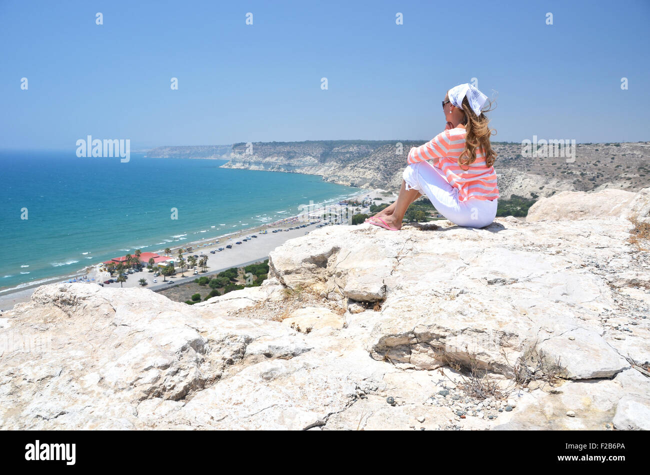 Girl on the rock looking to the ocean. Cyprus Stock Photo - Alamy