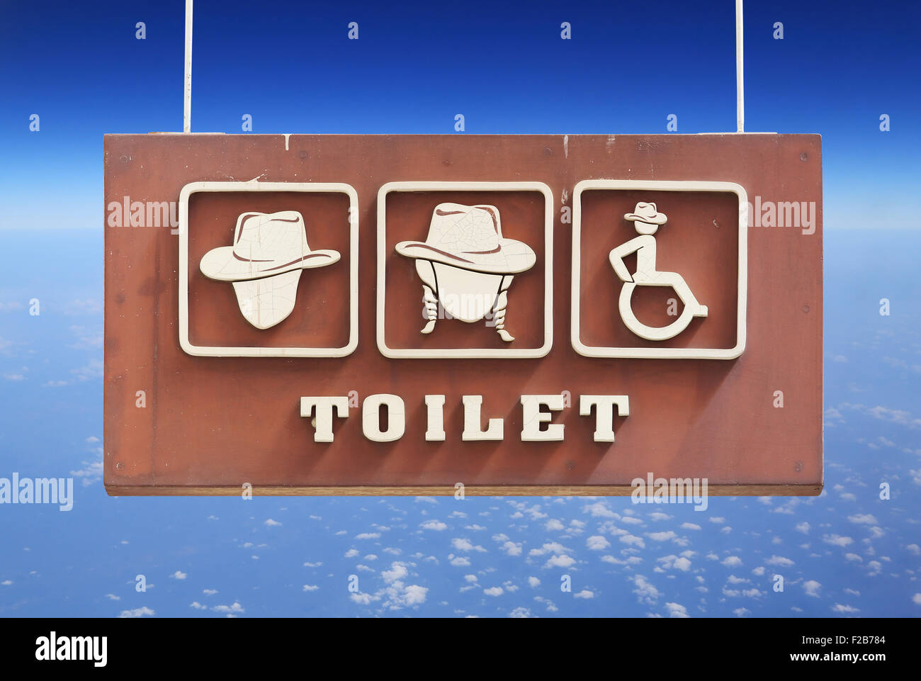 toilet sign hanging with blue sky background Stock Photo - Alamy