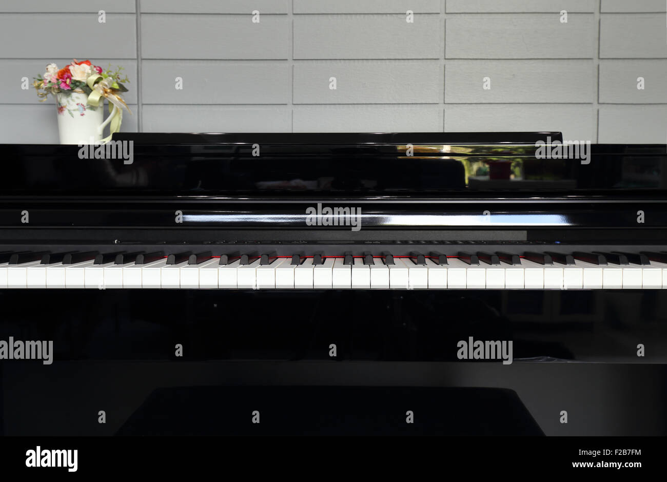 A black electronic piano with piano keys Stock Photo - Alamy