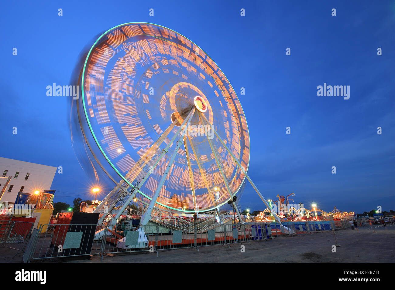 Ferris Wheel(motion) at amusement park at twilight time Stock Photo - Alamy