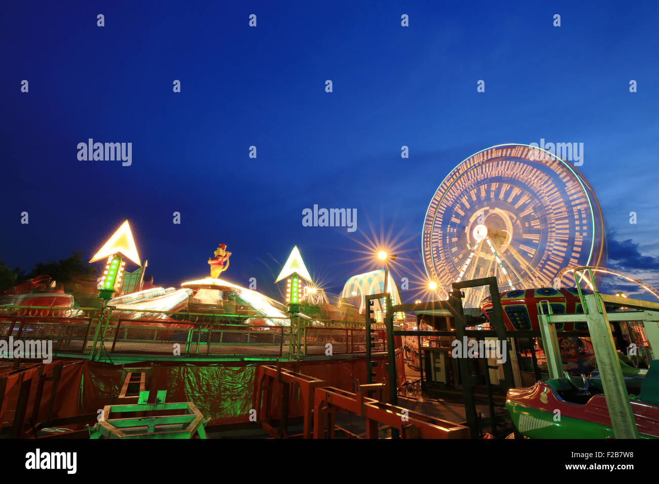 Amusement park at night with ferris wheel in motion Stock Photo - Alamy