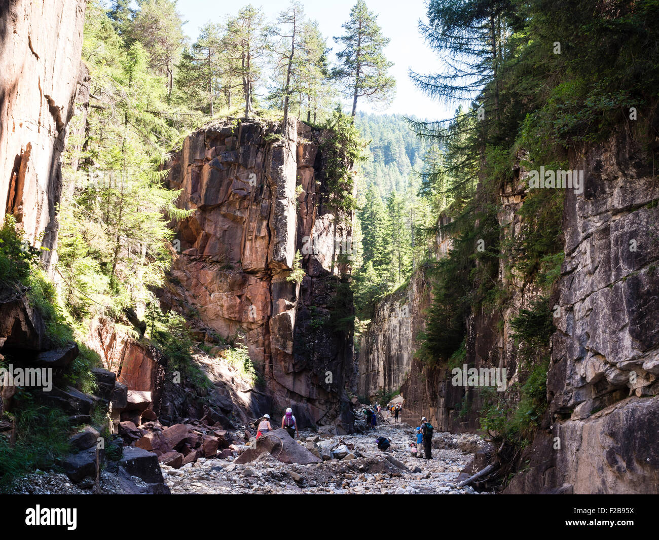 GEOPARC Bletterbach canyon, layers of sediments, stratum, people hike ...