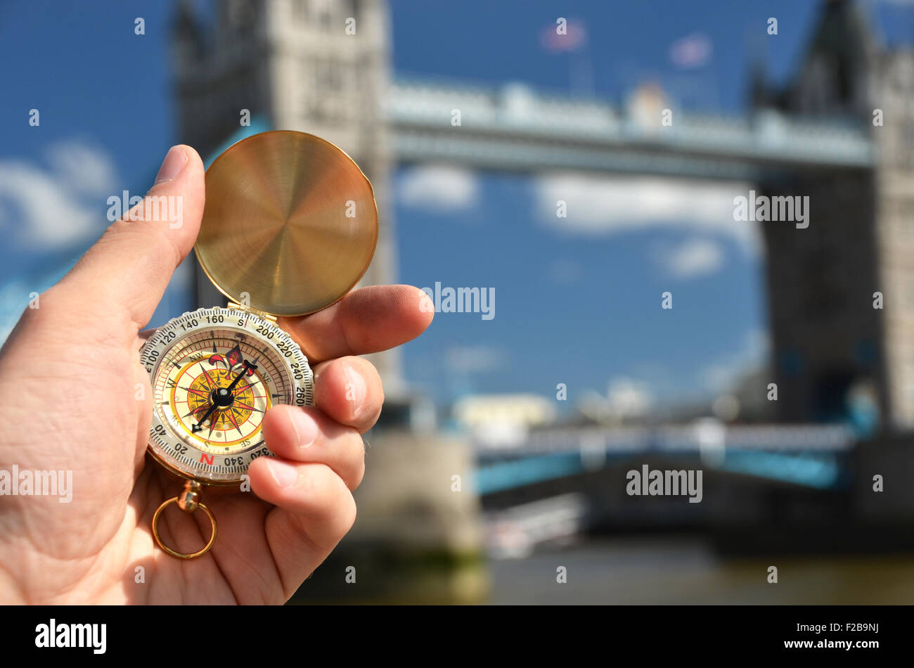 Compass in the hand against Tower bridge in London Stock Photo - Alamy