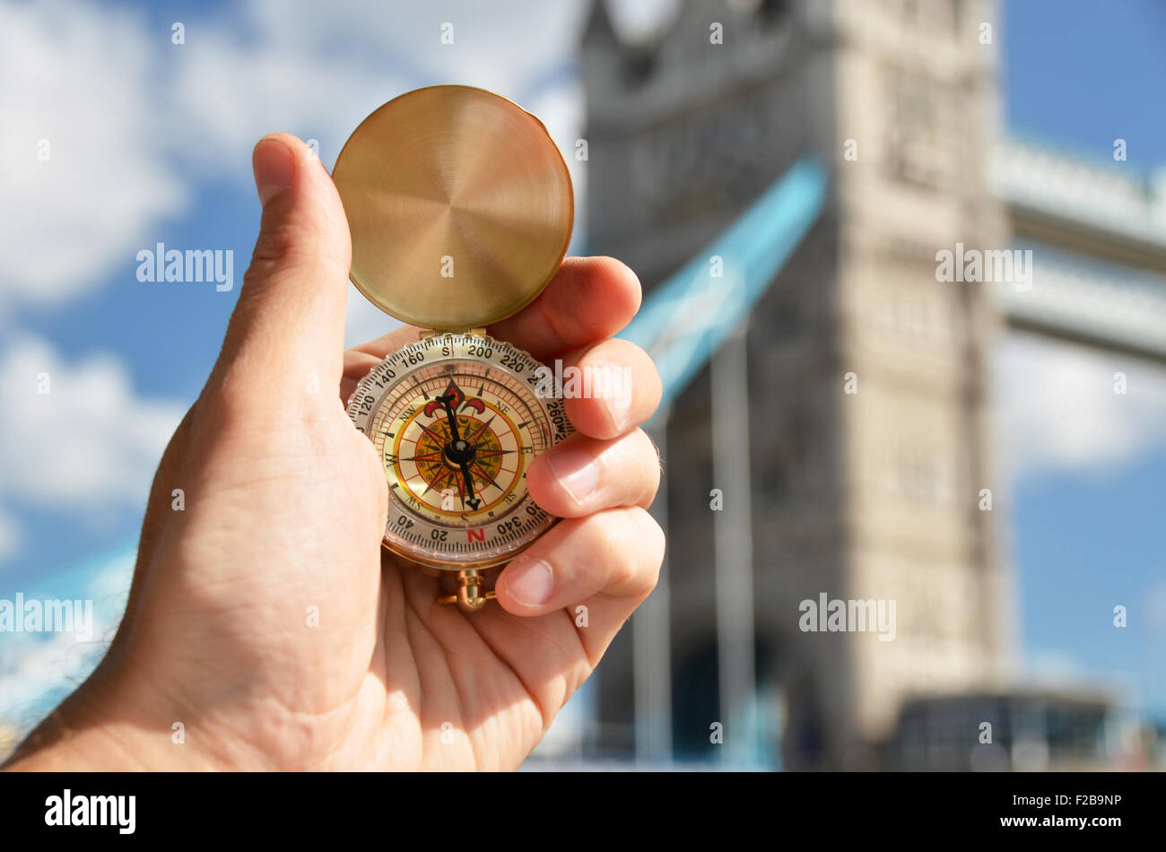 Compass in the hand against Tower bridge in London Stock Photo - Alamy