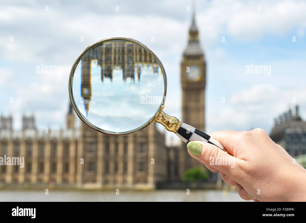 Magnifying glass in the hand against Big Ben in London Stock Photo - Alamy