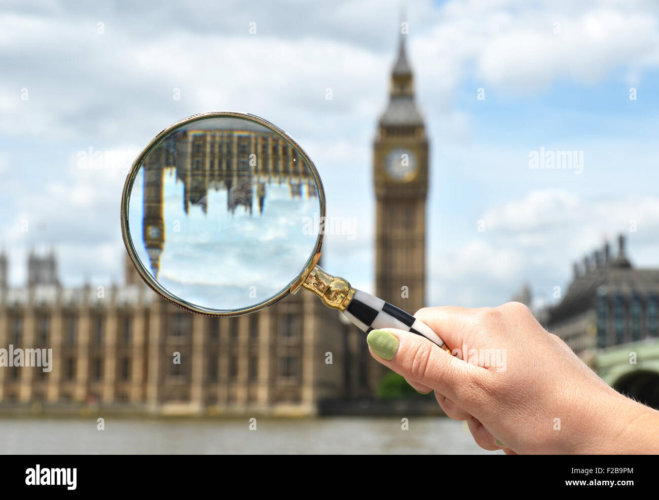 Magnifying glass in the hand against Big Ben in London Stock Photo - Alamy