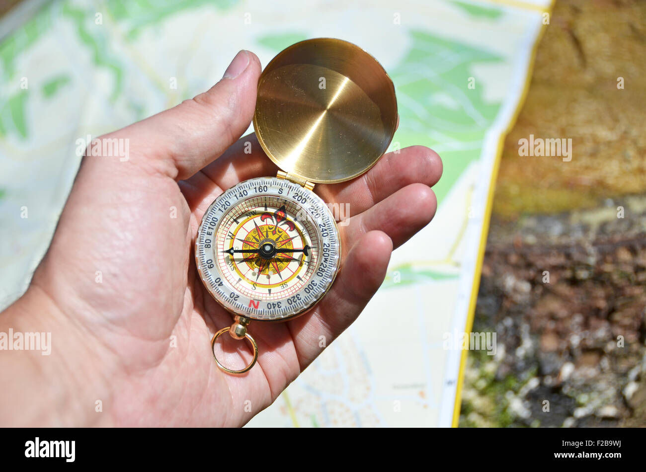 Vintage compass in the hand against a map Stock Photo - Alamy