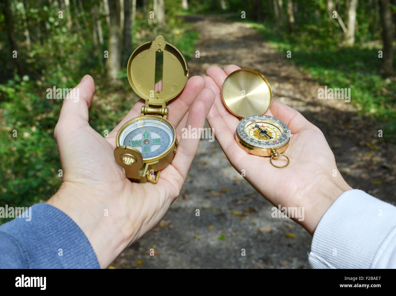 Two compasses in the hands Stock Photo - Alamy