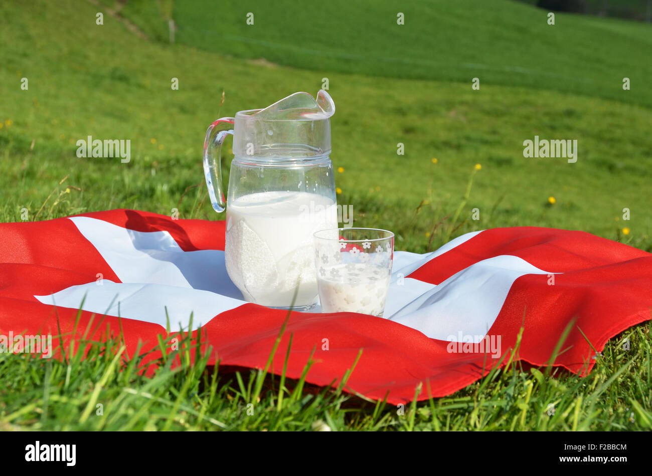 Jug of milk on the Swiss flag. Emmental, Switzerland Stock Photo - Alamy
