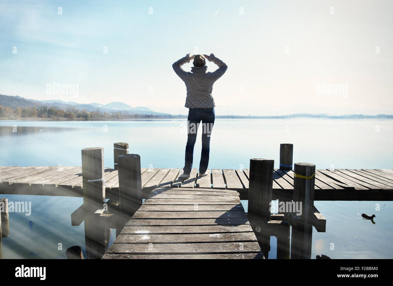 Girl on the wooden jetty. Switzerland Stock Photo - Alamy