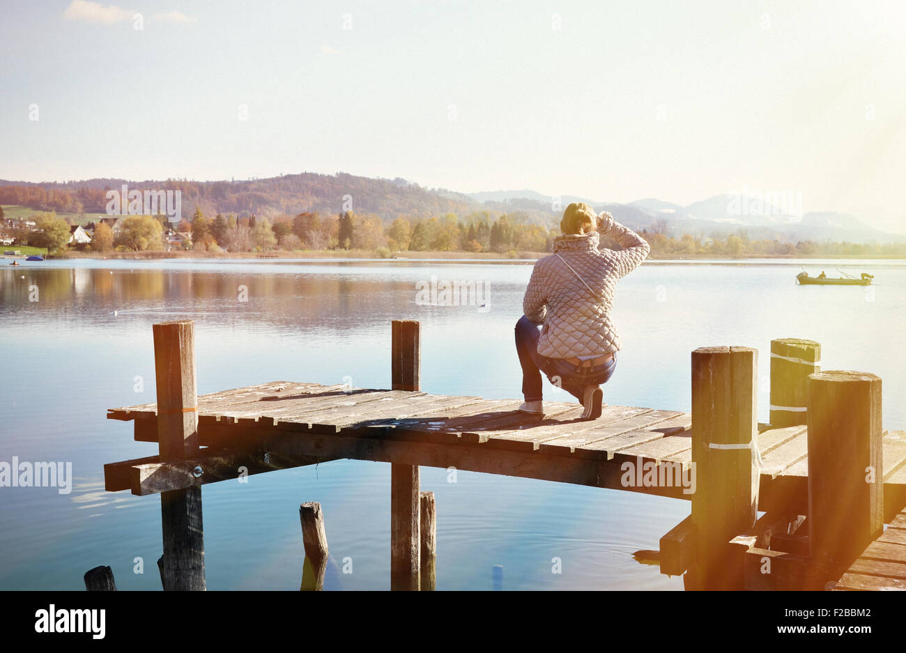 Girl on the wooden jetty. Switzerland Stock Photo - Alamy
