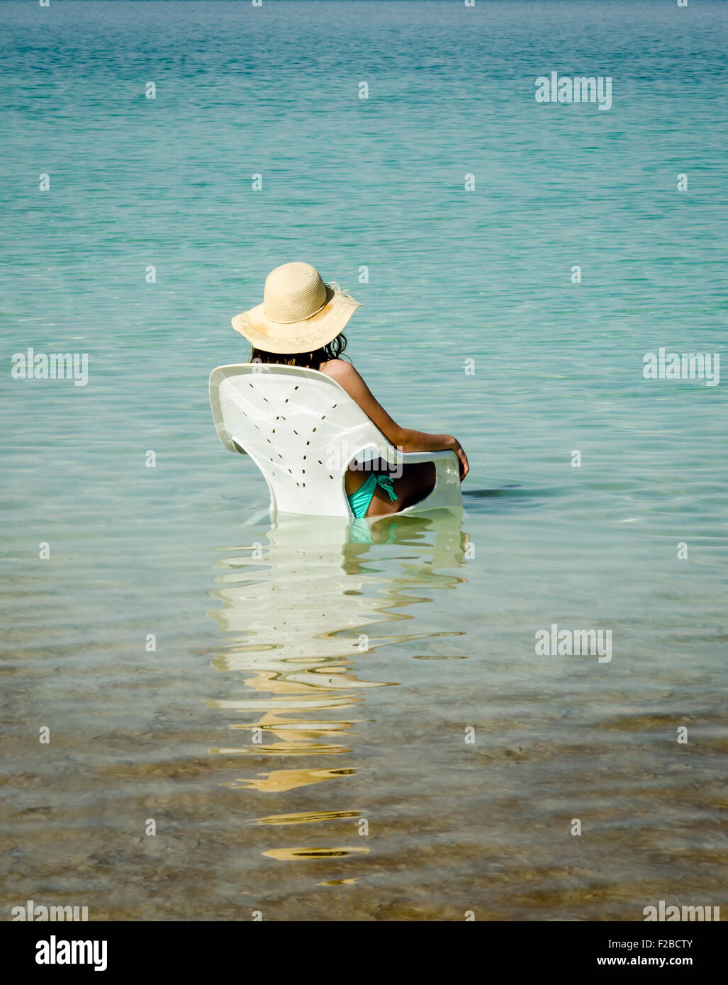 Woman sitting in beach chair hi-res stock photography and images - Alamy