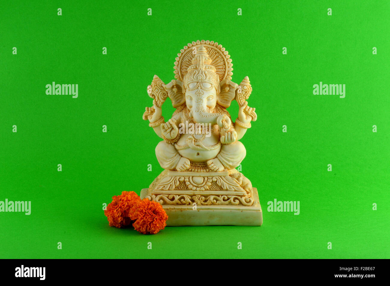 Hindu God Ganesha. Ganesha Idol with flowers Stock Photo - Alamy