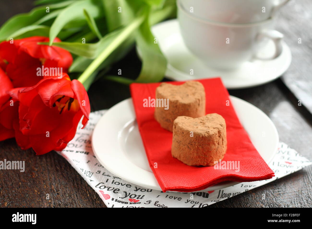 Cakes truffles with red tulips Stock Photo - Alamy