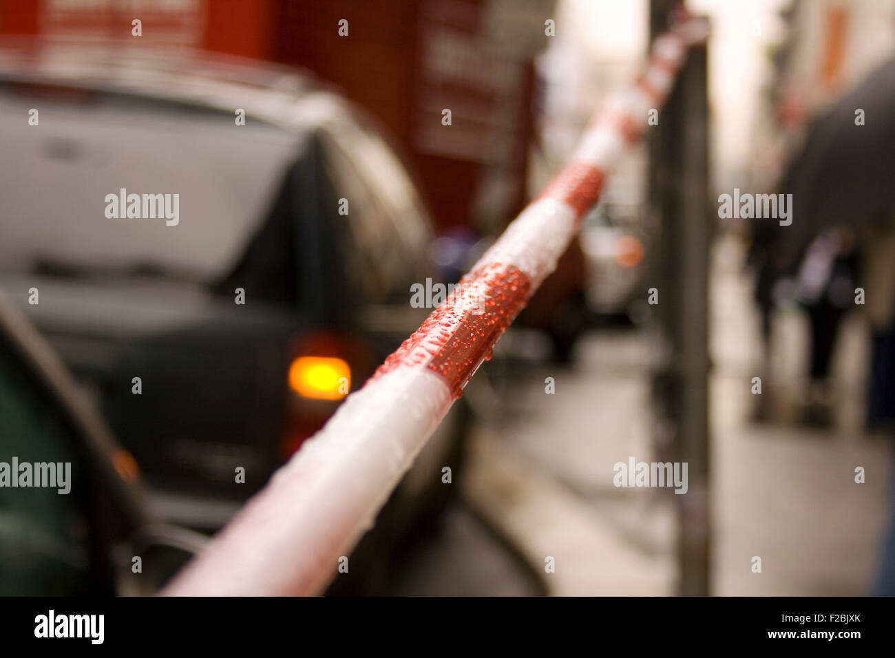 Red and white Band signaling next to a car Stock Photo - Alamy