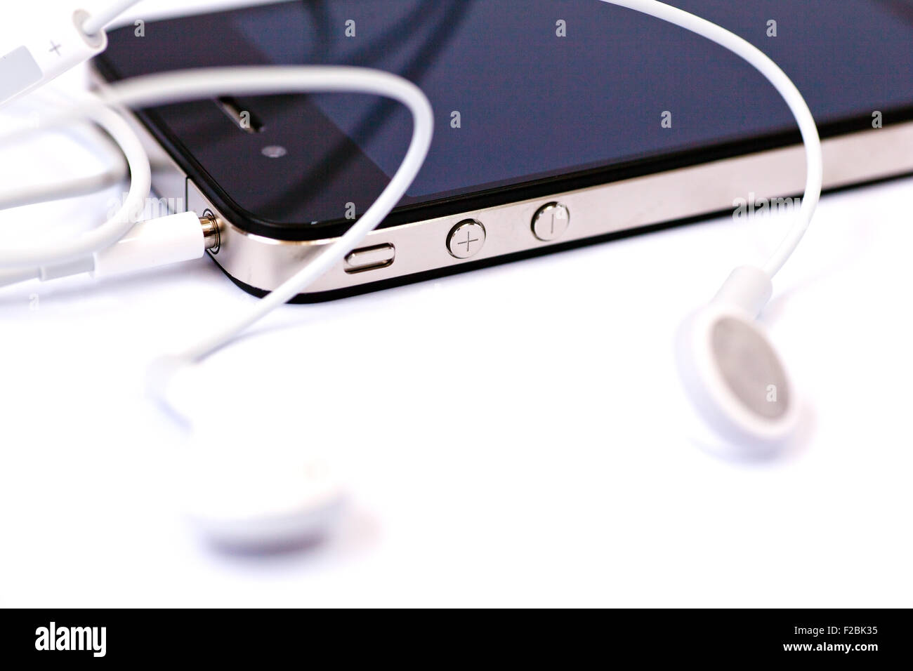 Smart phone and headphones isolated on a white background Stock Photo ...