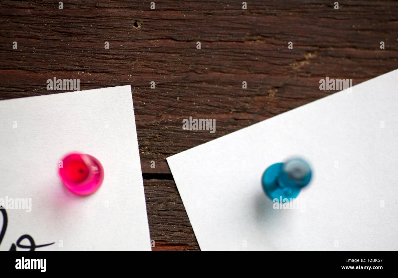 Push pins on paper and wood Stock Photo - Alamy