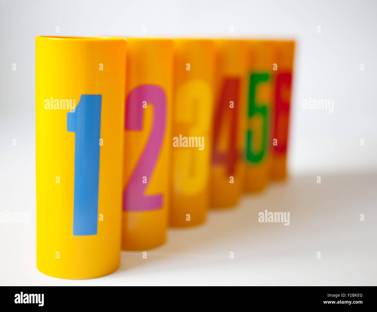 Yellow plastic cans numbered one to six - colored numbers Stock Photo ...