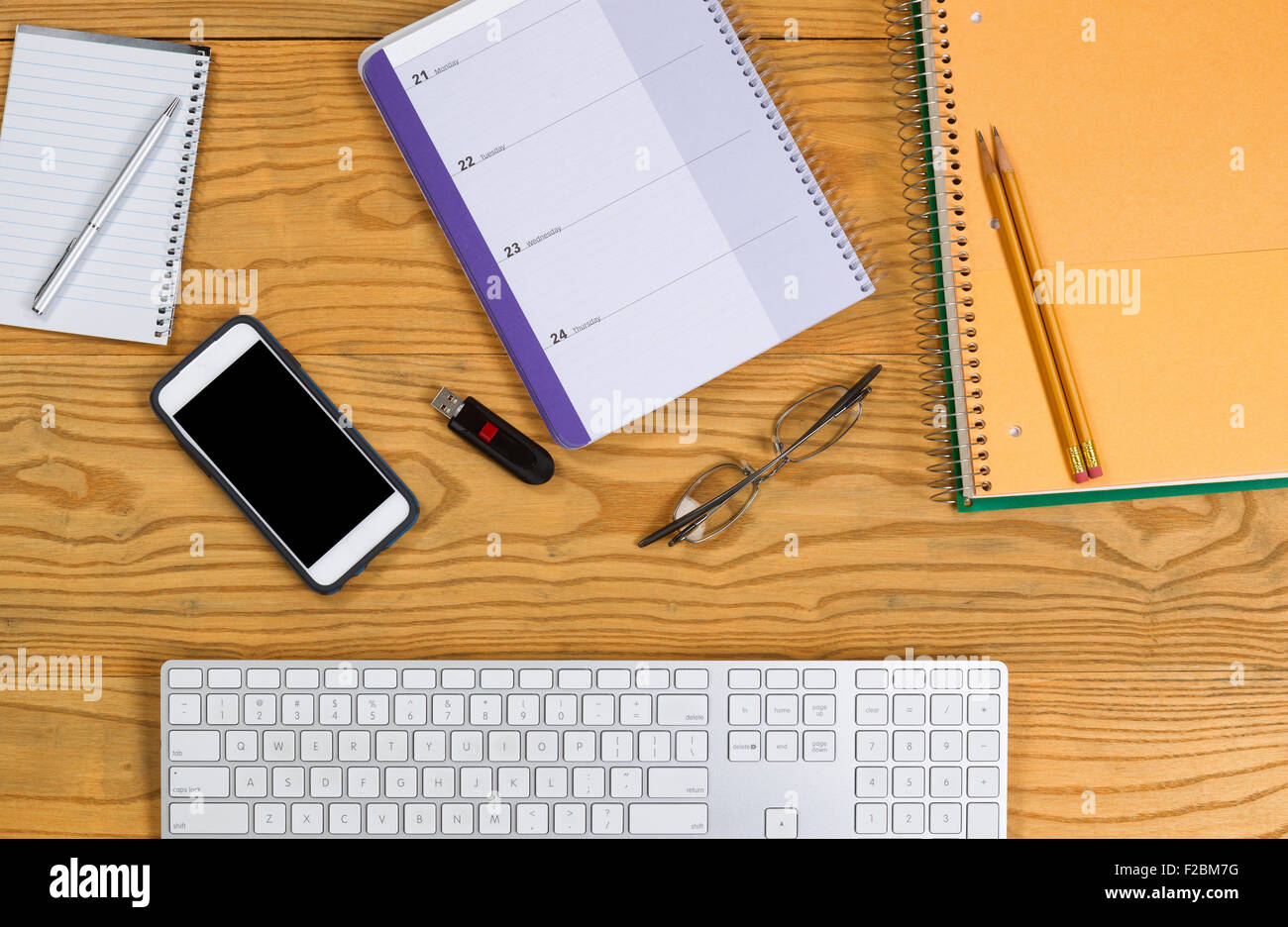 High angled view of desktop consisting of computer keyboard, pencils ...