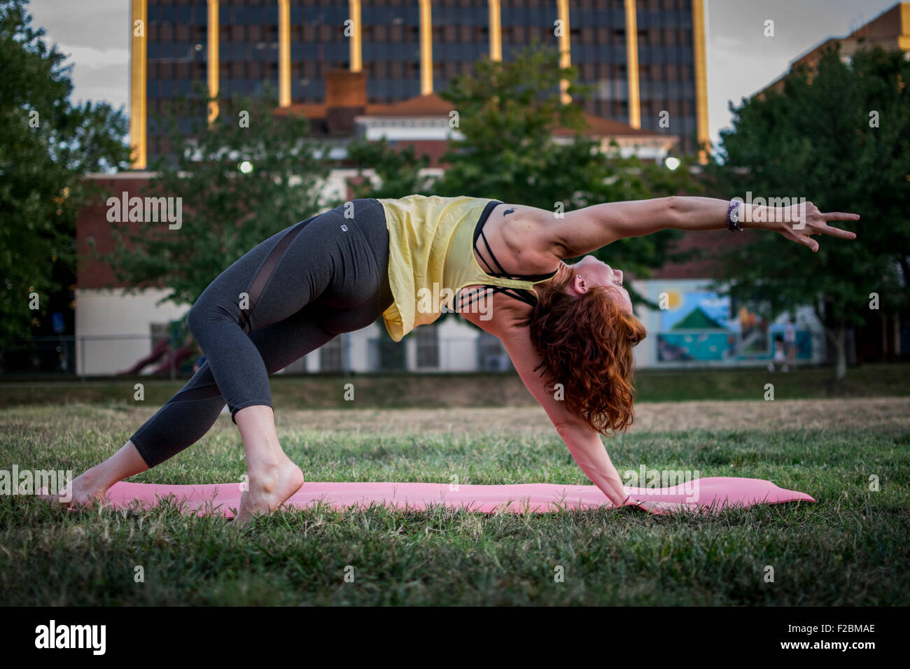 Attractive young woman practicing yoga in the park (Back Bend Stock ...