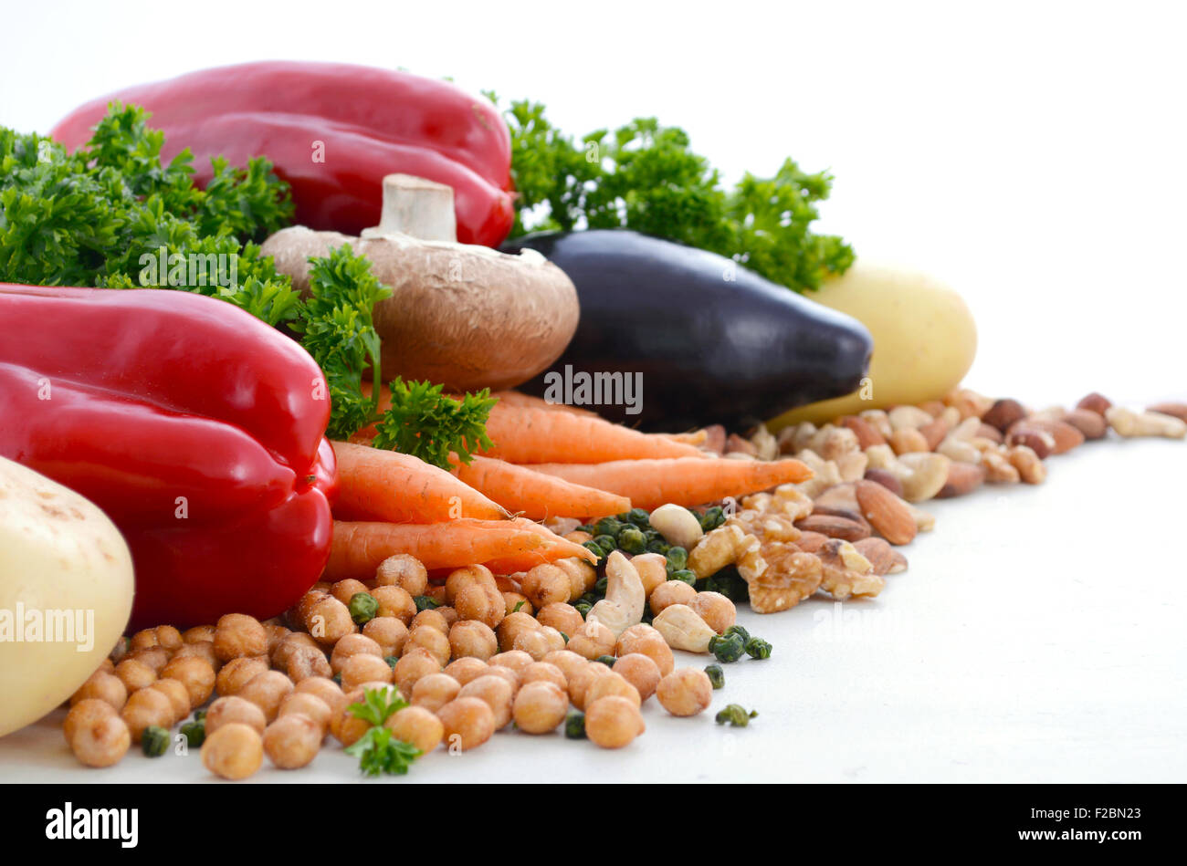 Vegetarian food including vegetables, nuts and legumes with copy space ...