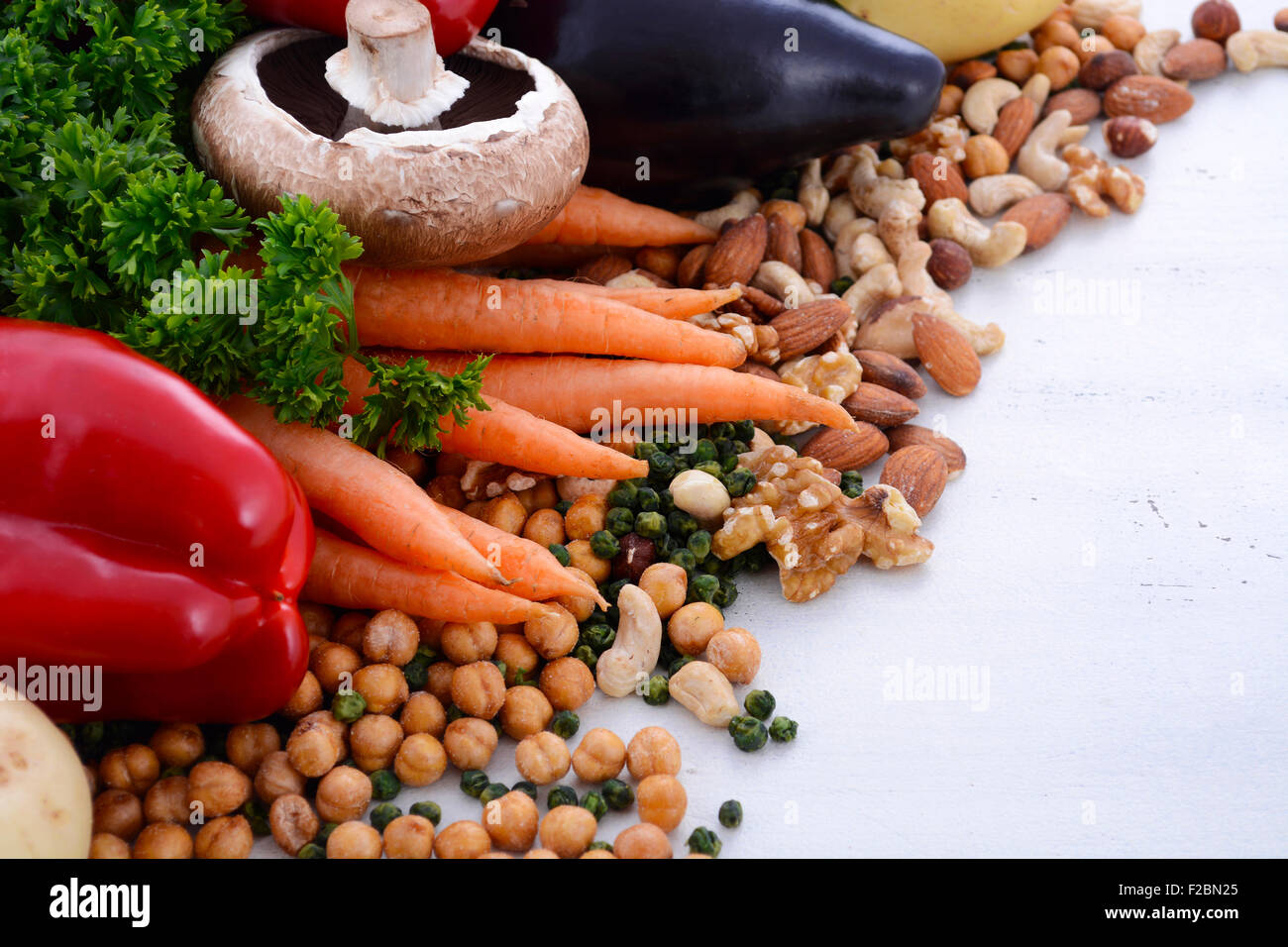 Vegetarian food including vegetables, nuts and legumes with copy space ...
