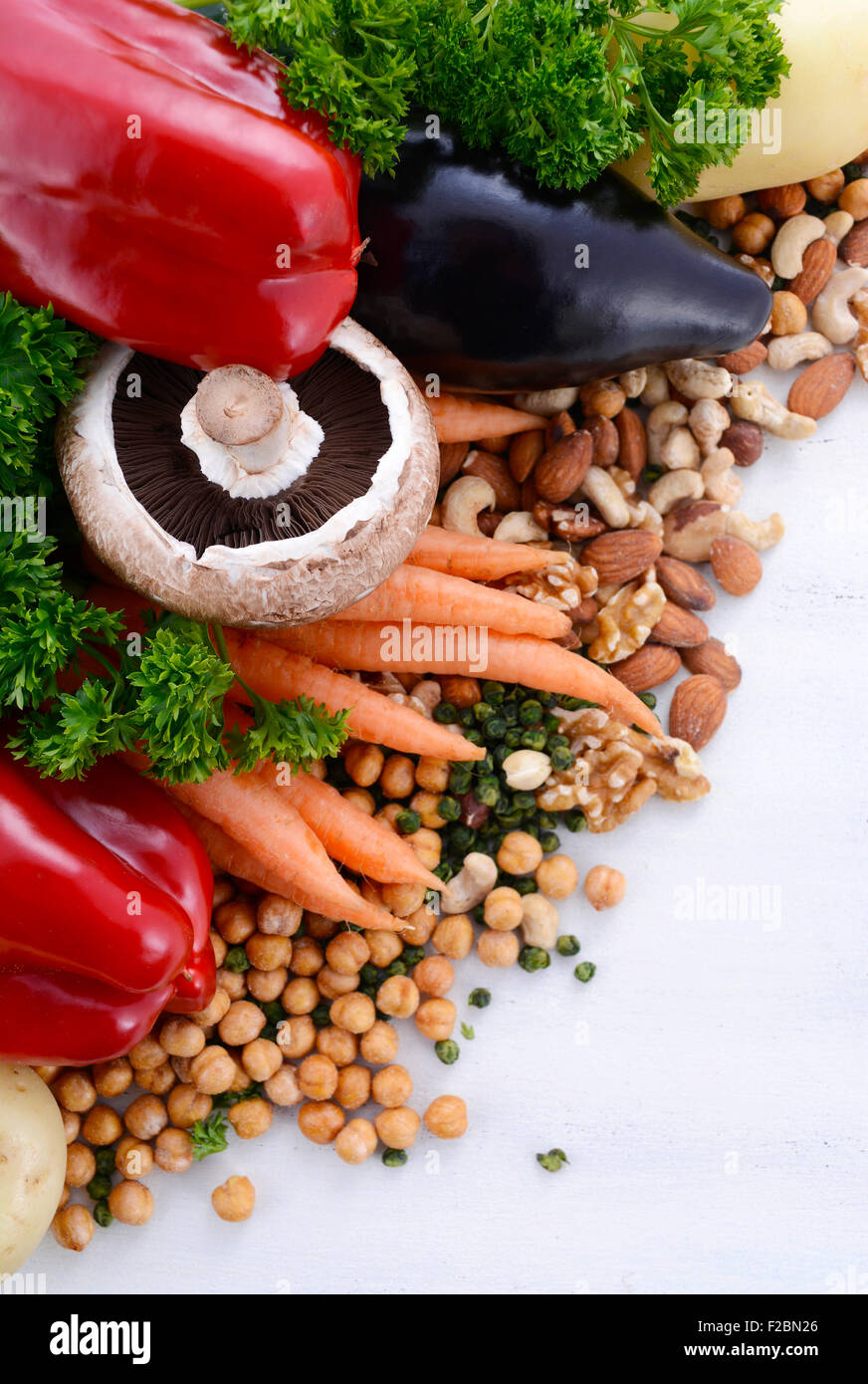 Vegetarian food including vegetables, nuts and legumes with copy space ...