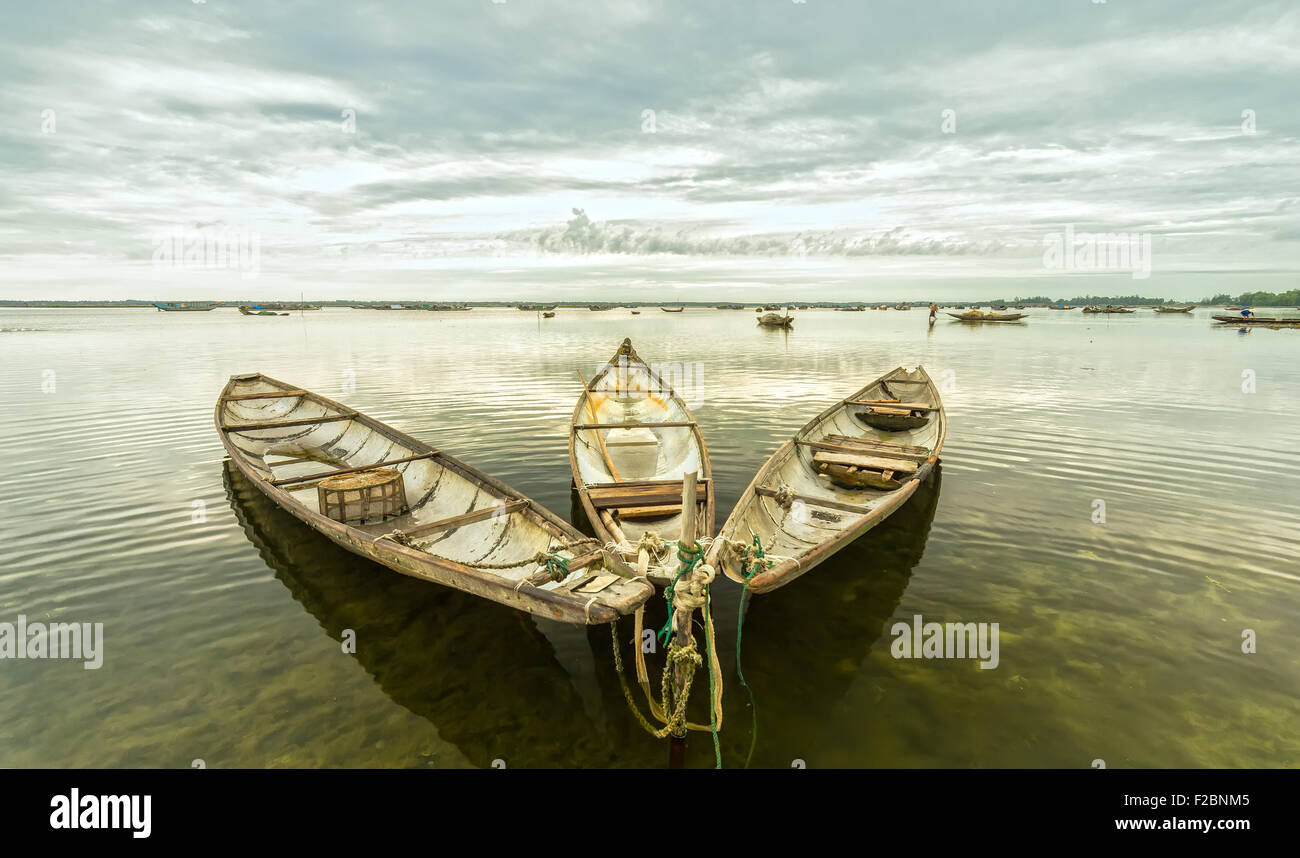 Three boats together to welcome the new day reflected the still lake ...