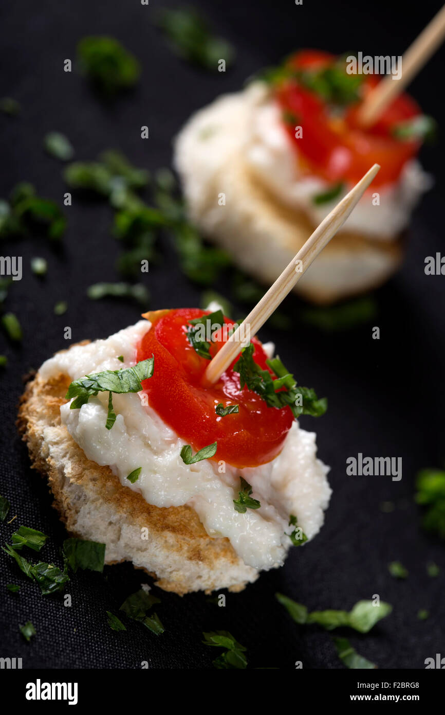 Roe salad appetizer with bread and tomatoes Stock Photo - Alamy