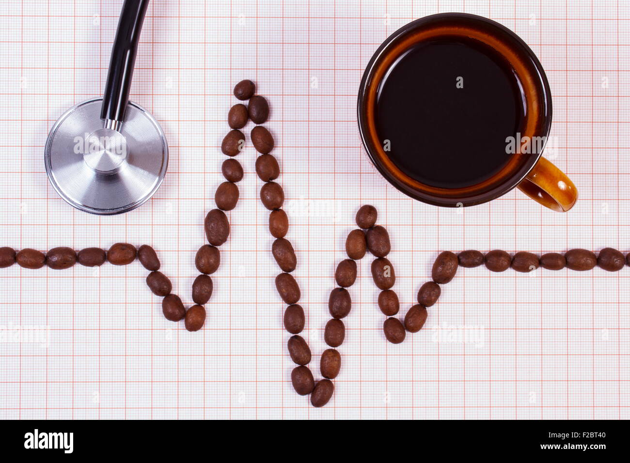 Electrocardiogram line of roasted coffee grains, cup of hot coffee and ...