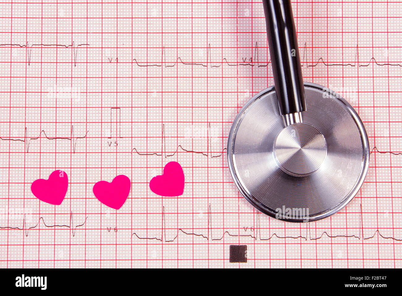 Hearts of paper and medical stethoscope lying on electrocardiogram ...